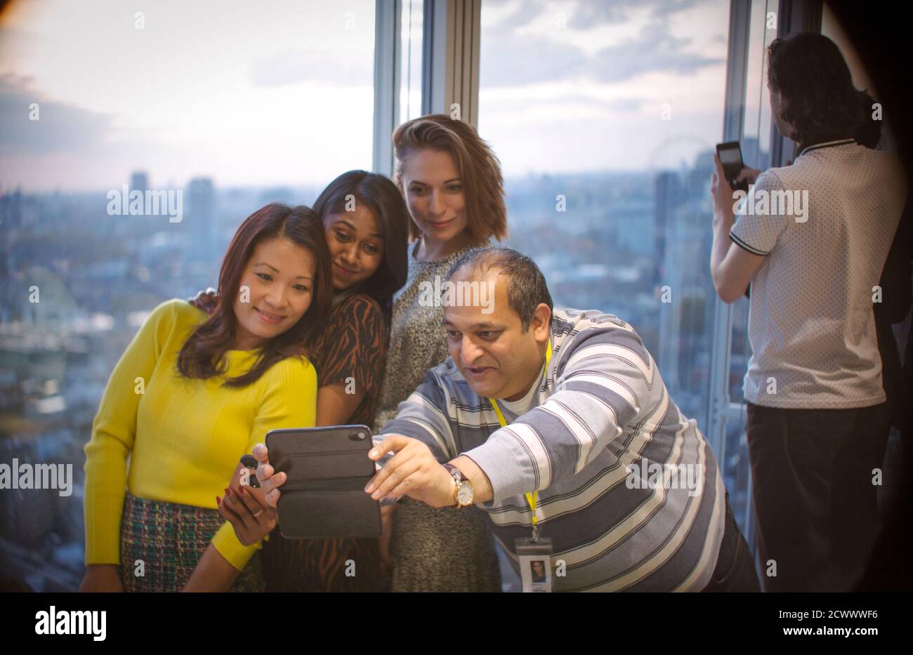 Business people taking selfie at highrise office window Stock Photo - Alamy