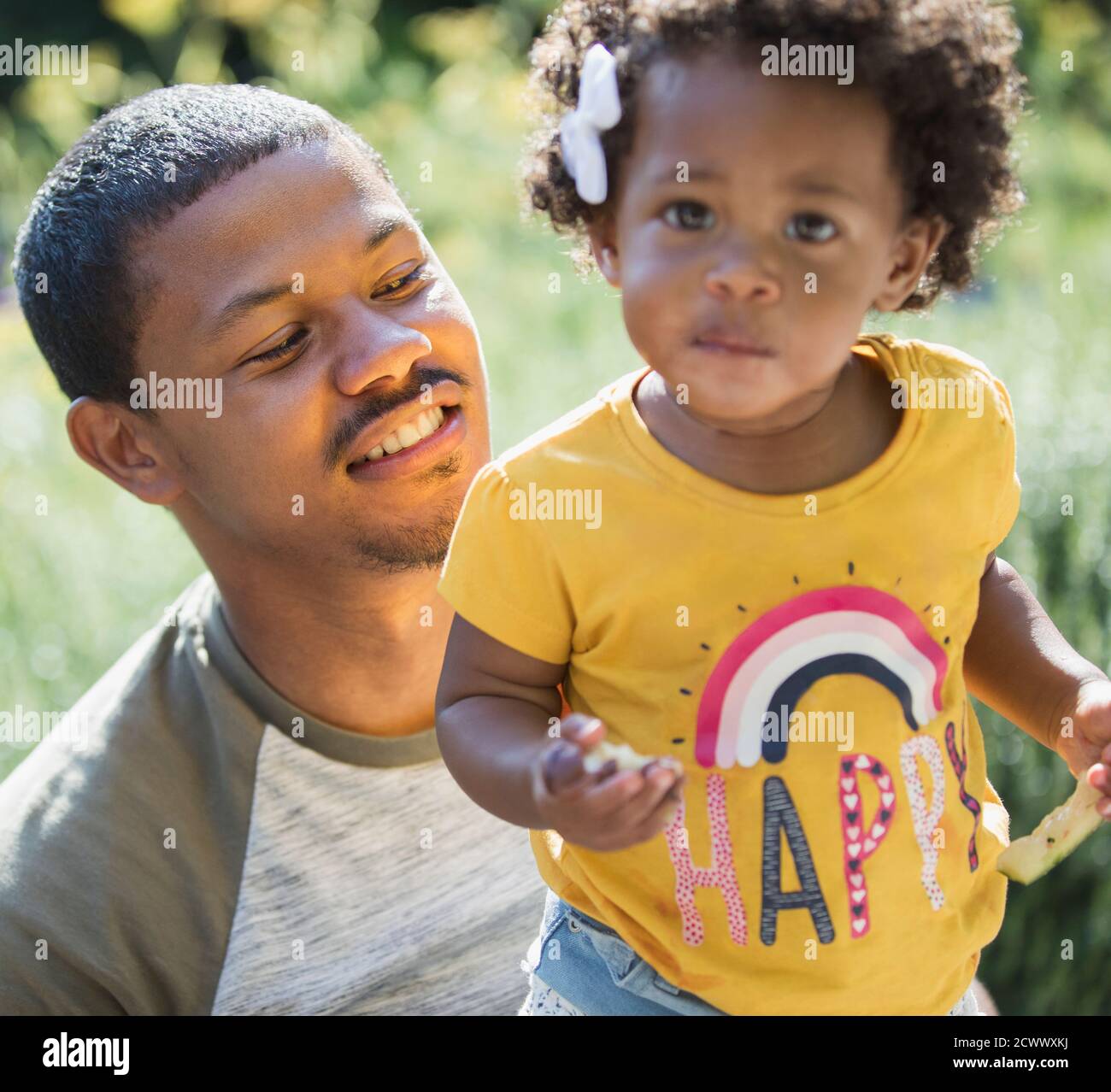 Portrait father holding cute messy toddler daughter Stock Photo - Alamy