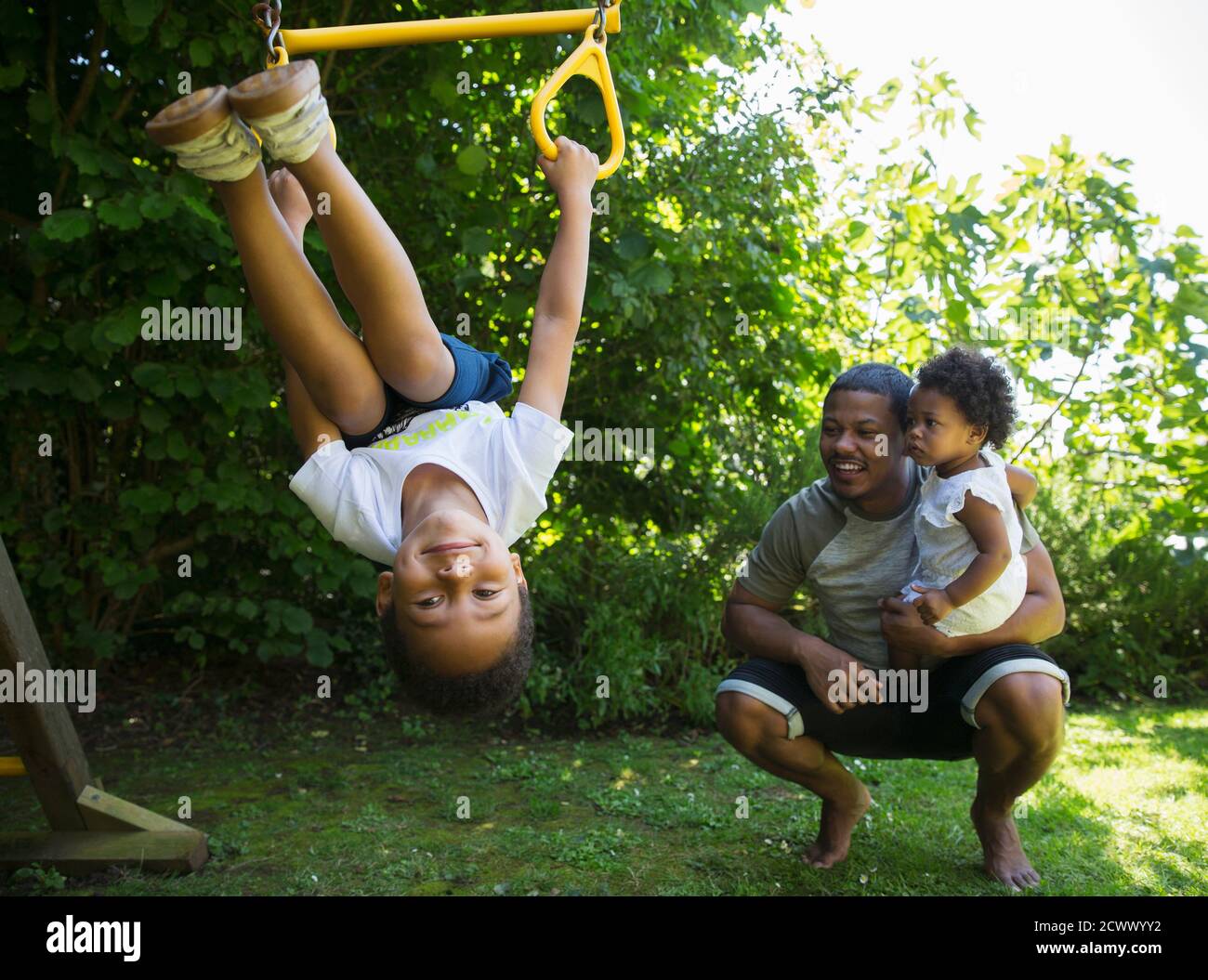 Happy family playing in summer backyard Stock Photo - Alamy