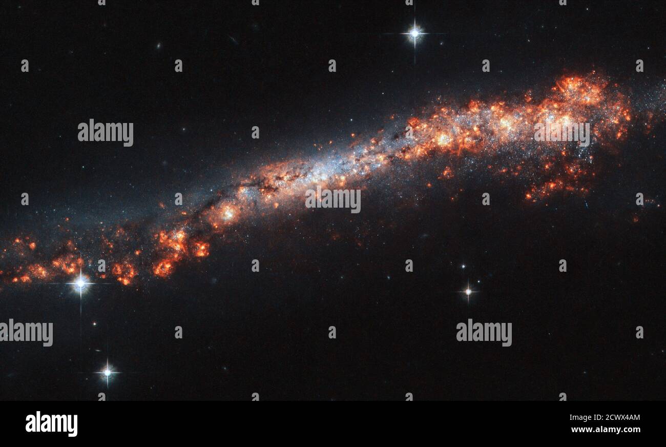 The Hubble Space Telescope captures the galaxy NGC 3432, a spiral ...