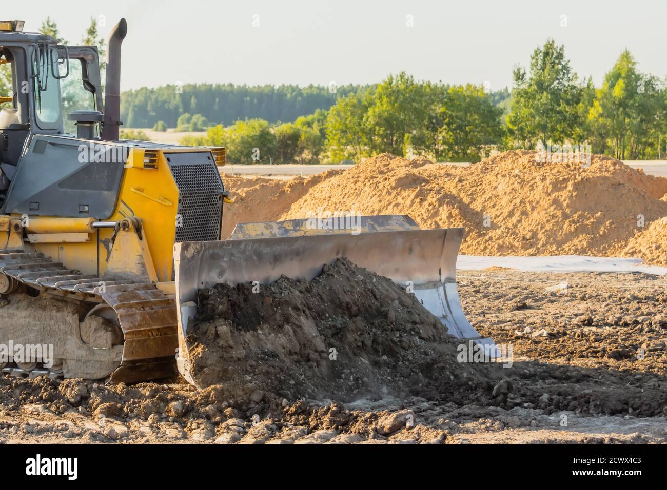 The bulldozer levels the ground during the construction of engineering ...