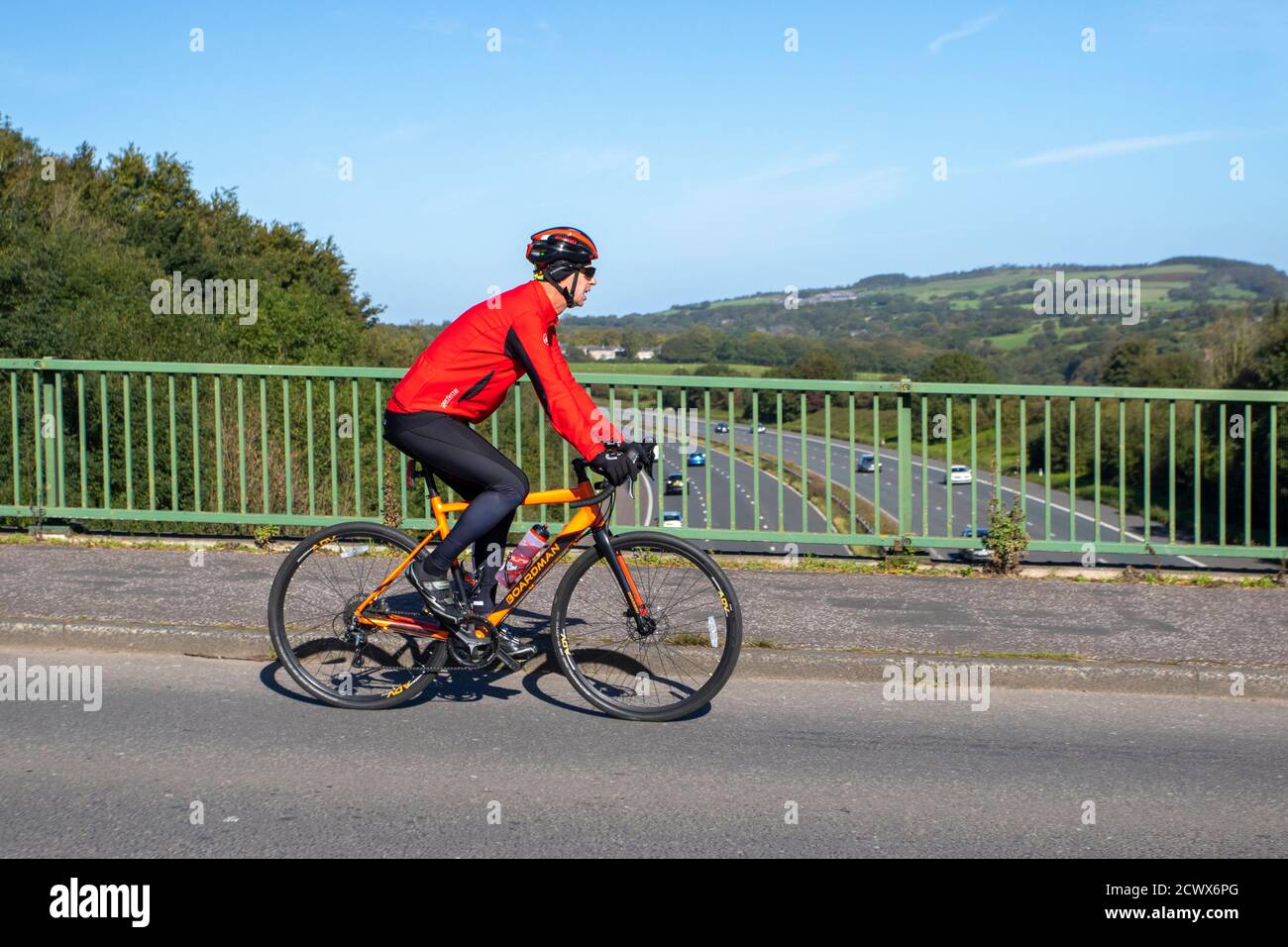 Male cyclist riding Boardman sports road bike on countryside route ...