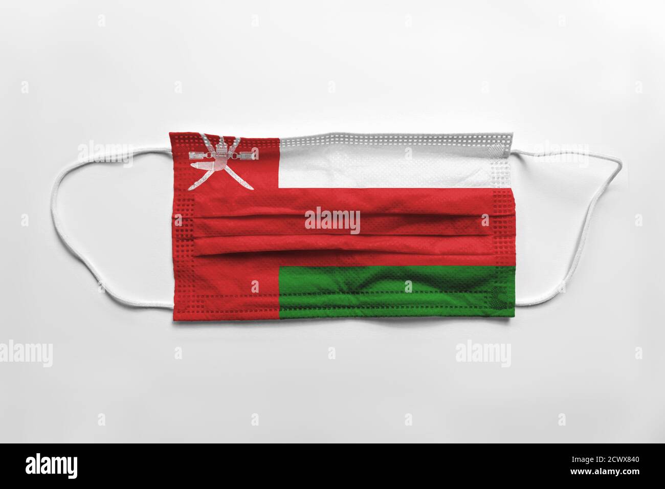Face mask with Oman flag printed, on white background, isolated. Covid ...