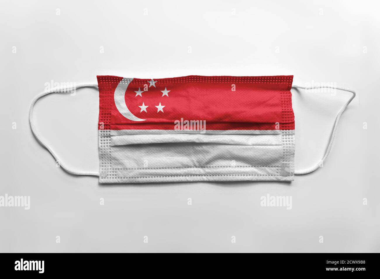 Face mask with Singapore flag printed, on white background, isolated ...