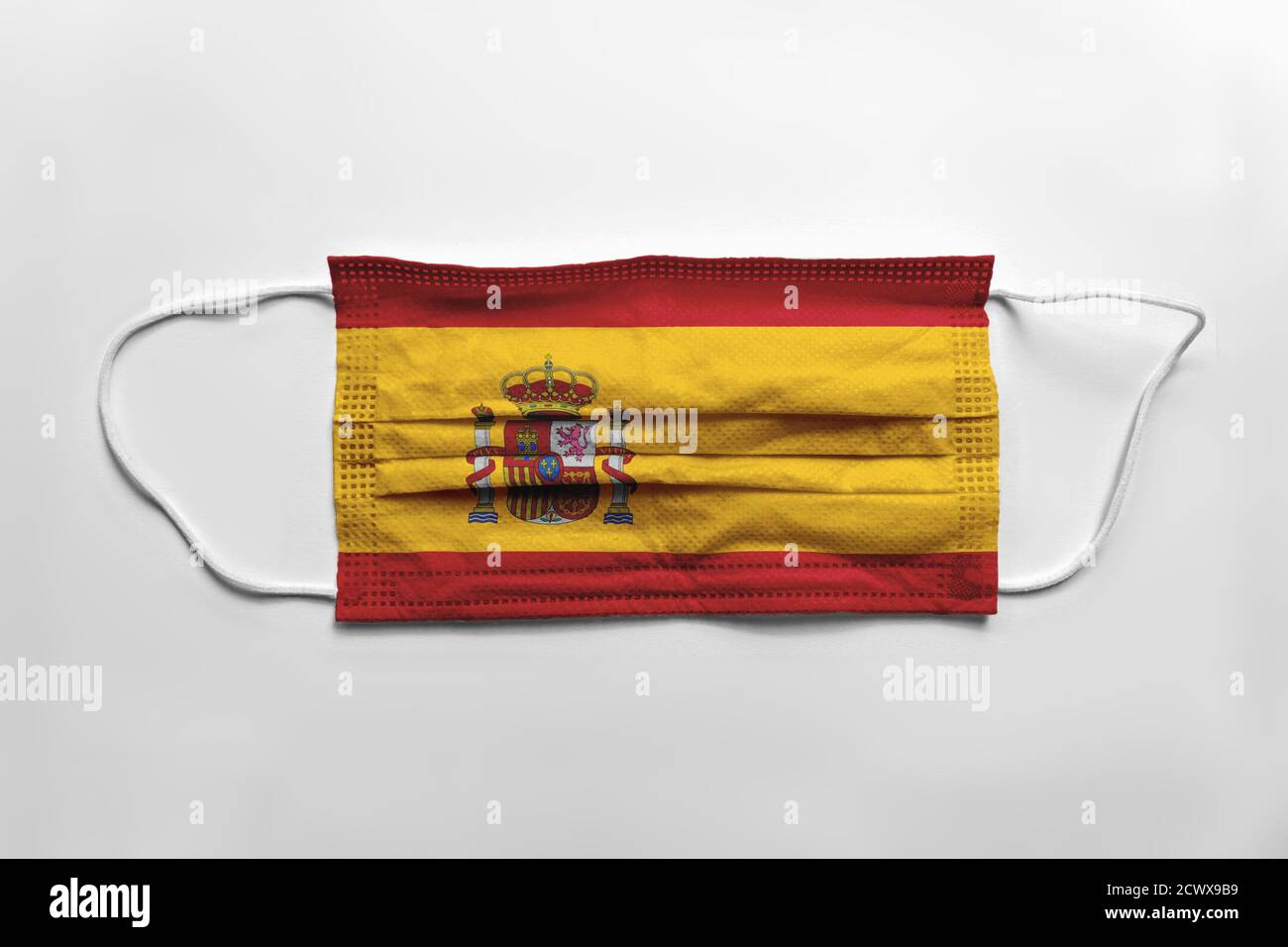 Face mask with Spain flag printed, on white background, isolated. Covid ...