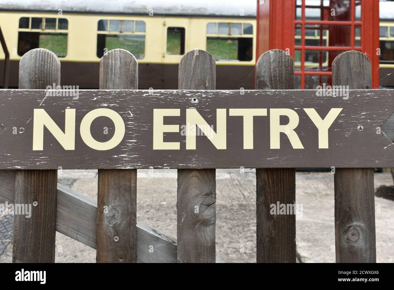 close up of No Entry sign in yellow print on wooden gate outside in ...