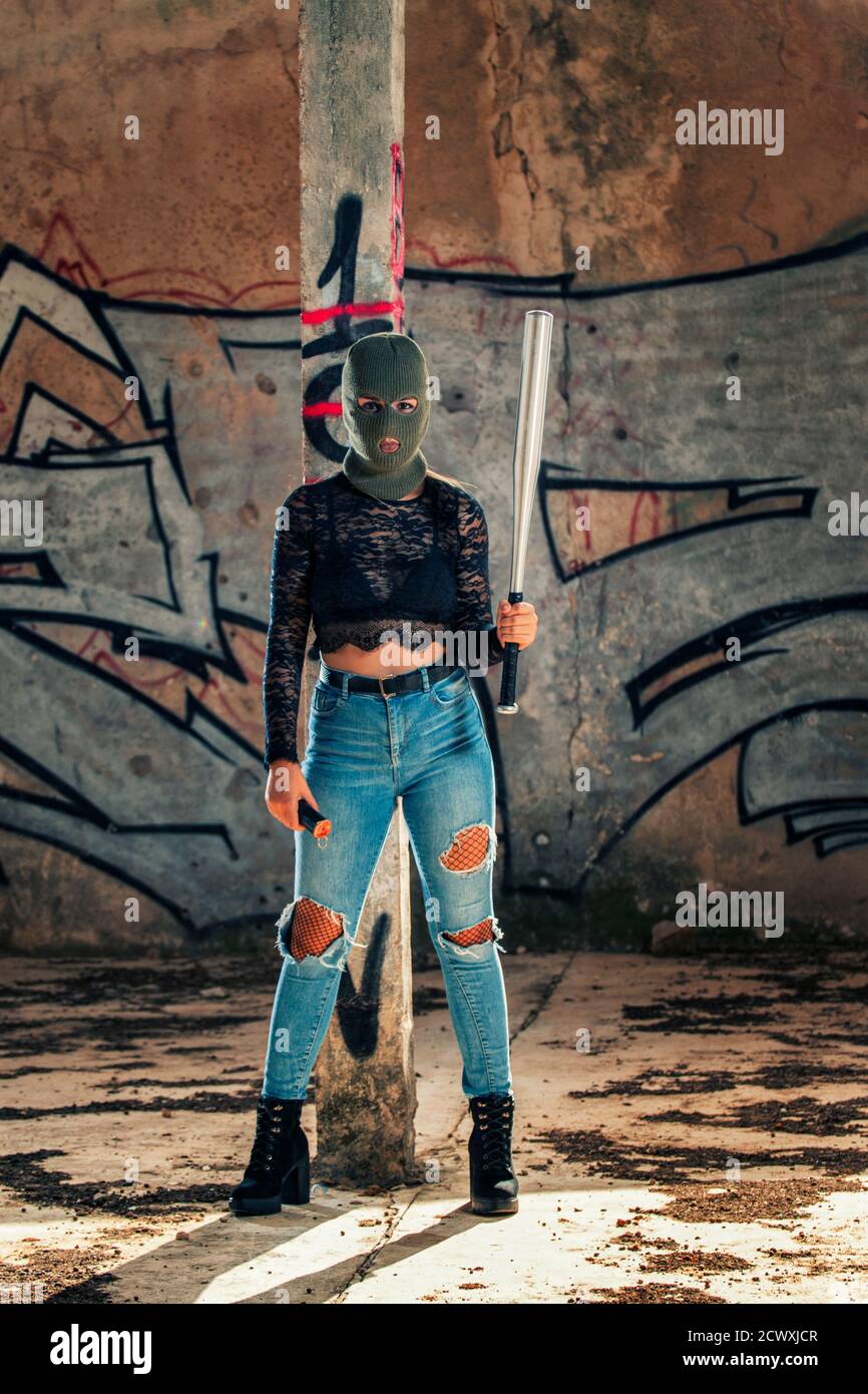Dangerous girl with bat and balaclava on a abandoned factory Stock ...