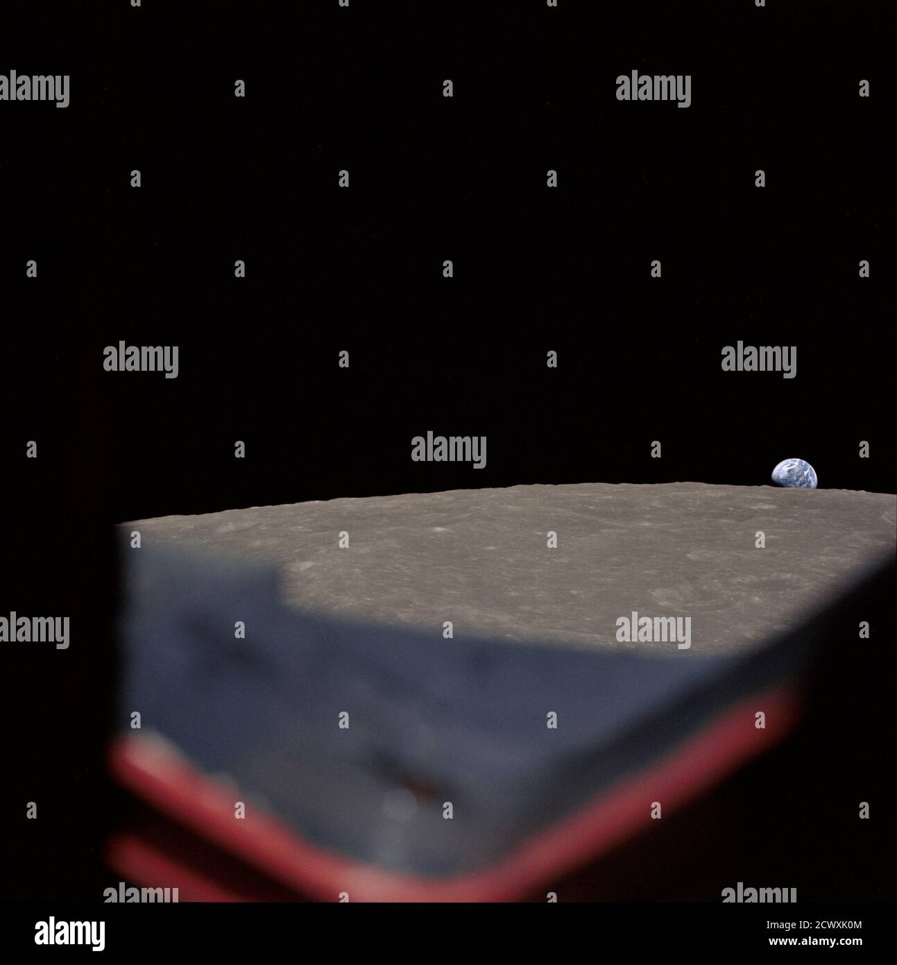 A high-oblique view of the Moon's surface with Earth rising above the ...