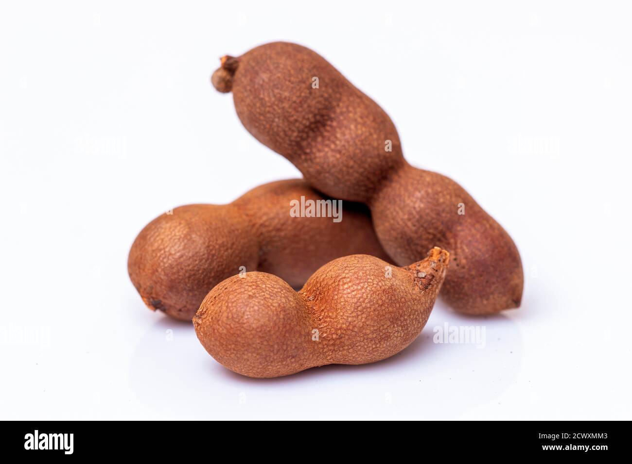 Tamarind fruit pods isolated on a white background Stock Photo - Alamy
