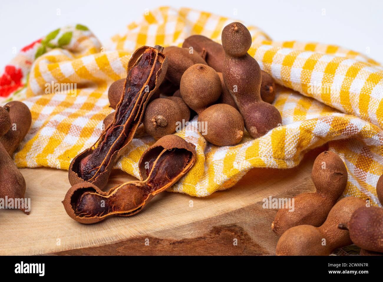 Tamarind fruit pods isolated on a white background Stock Photo - Alamy