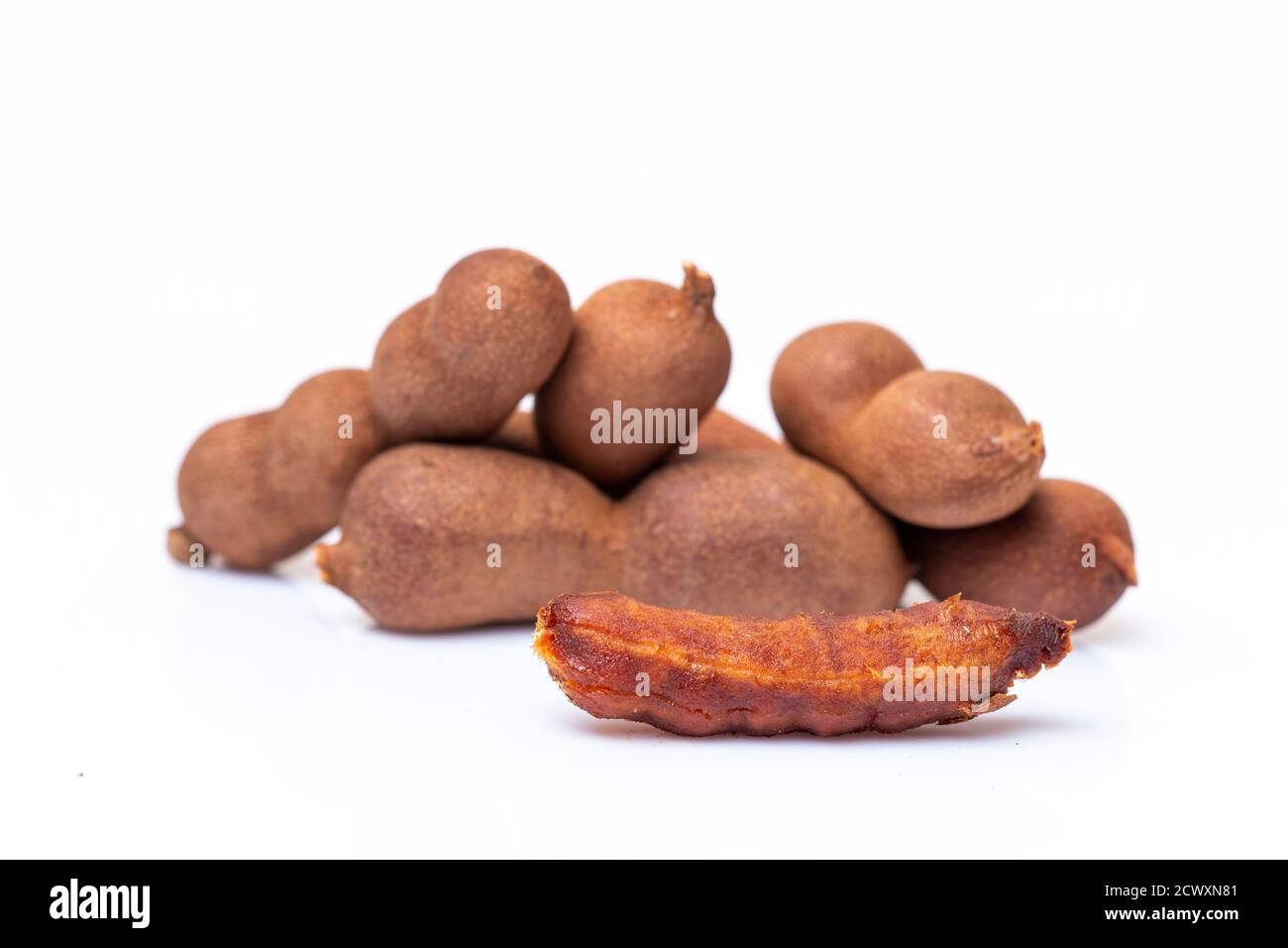 Tamarind fruit pods isolated on a white background Stock Photo - Alamy
