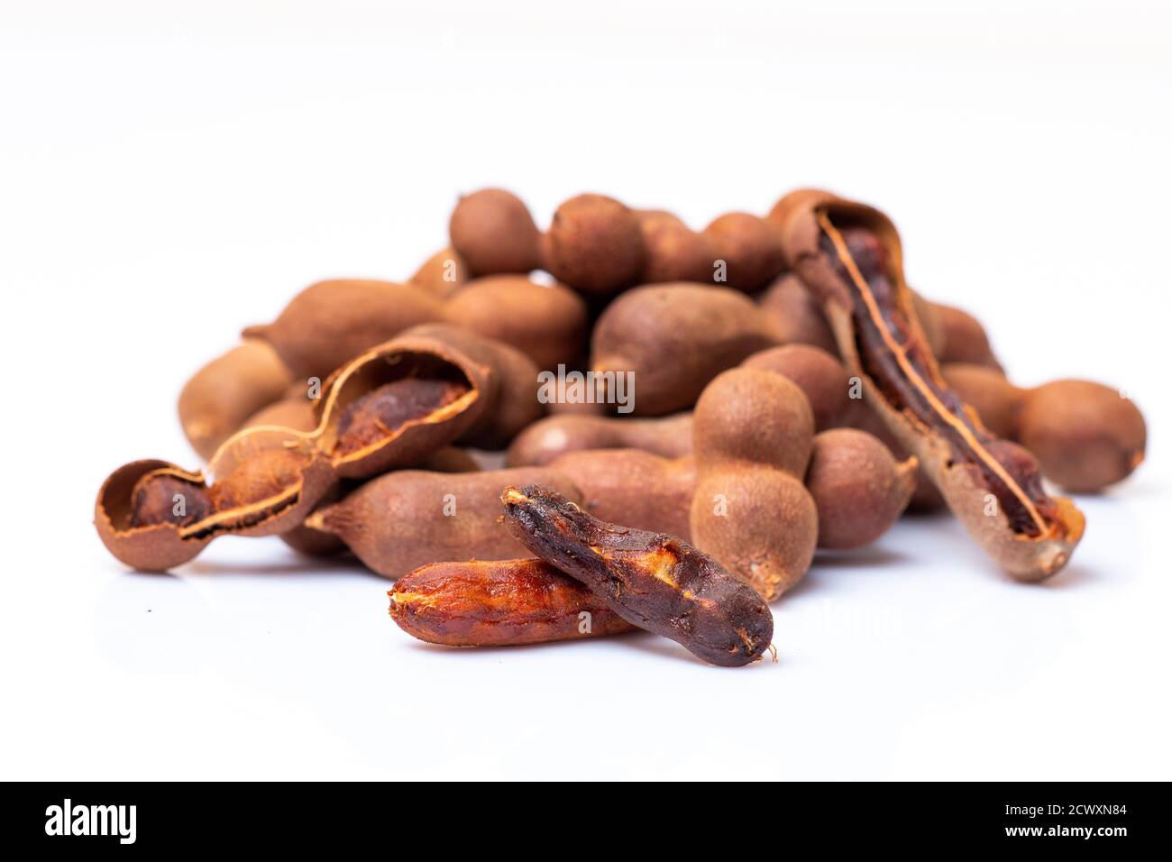 Tamarind fruit pods isolated on a white background Stock Photo - Alamy