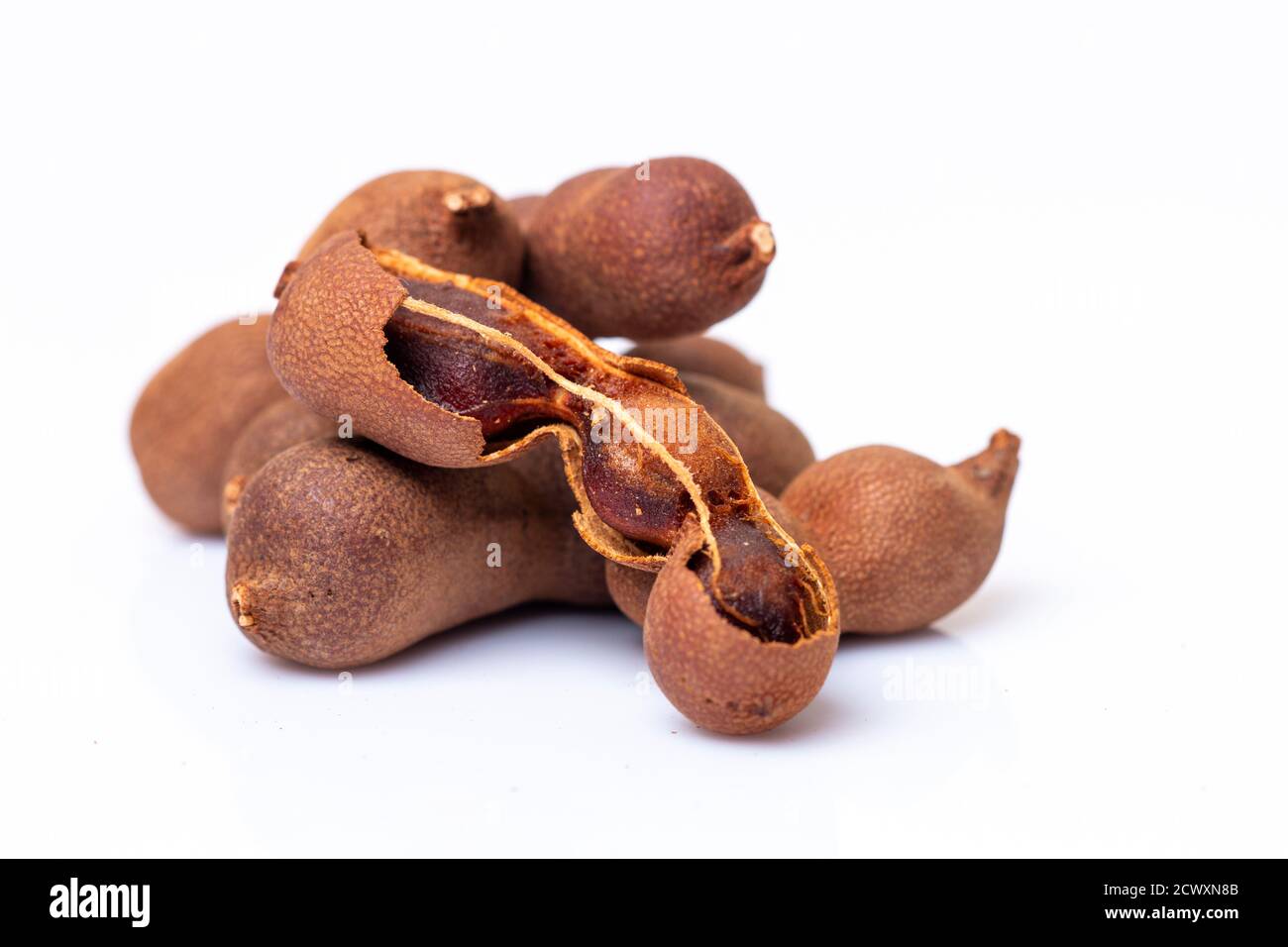 Tamarind fruit pods isolated on a white background Stock Photo - Alamy