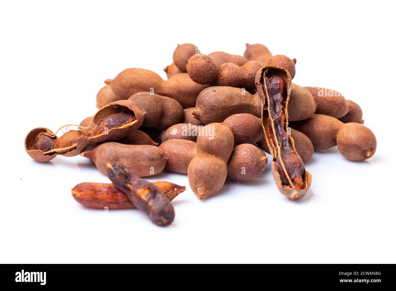 Tamarind fruit pods isolated on a white background Stock Photo - Alamy
