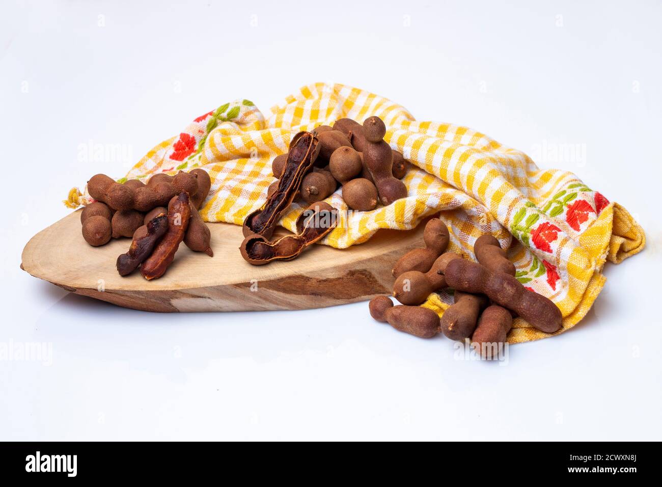 Tamarind fruit pods isolated on a white background Stock Photo - Alamy