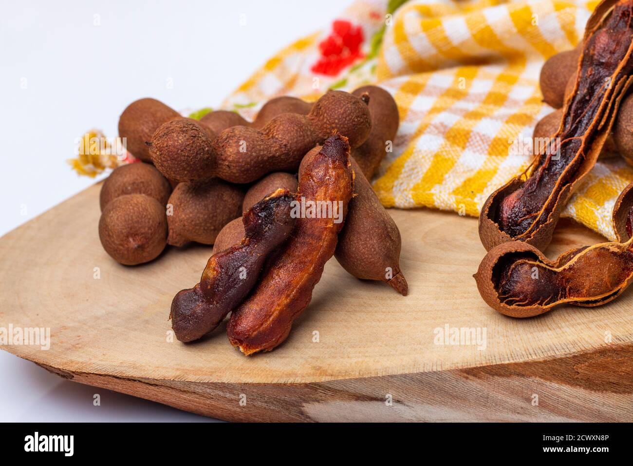 Tamarind fruit pods isolated on a white background Stock Photo - Alamy