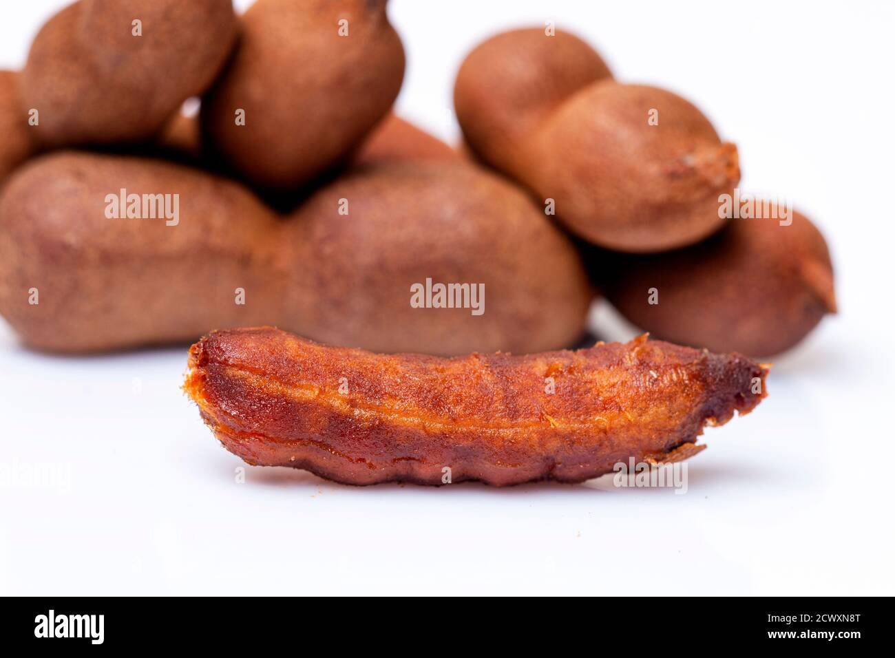 Tamarind fruit pods isolated on a white background Stock Photo - Alamy