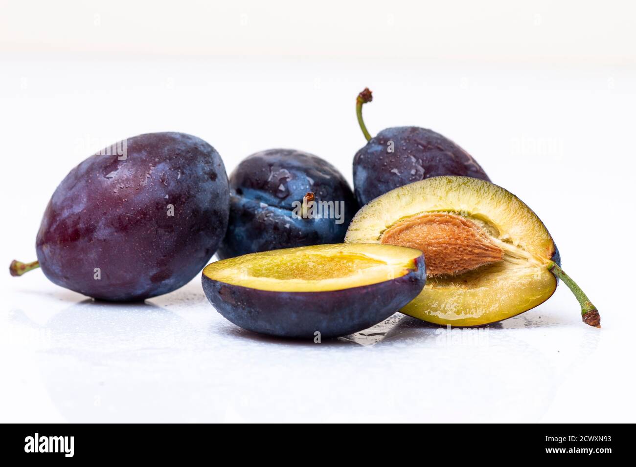 Fresh moyer purple plums isolated on a white background Stock Photo - Alamy