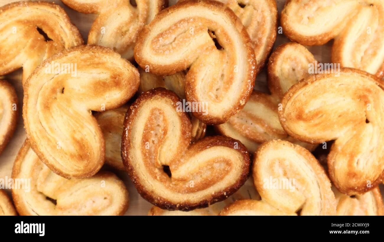 Fresh puff pastry palm cookies in the shape of a heart. Classic French ...