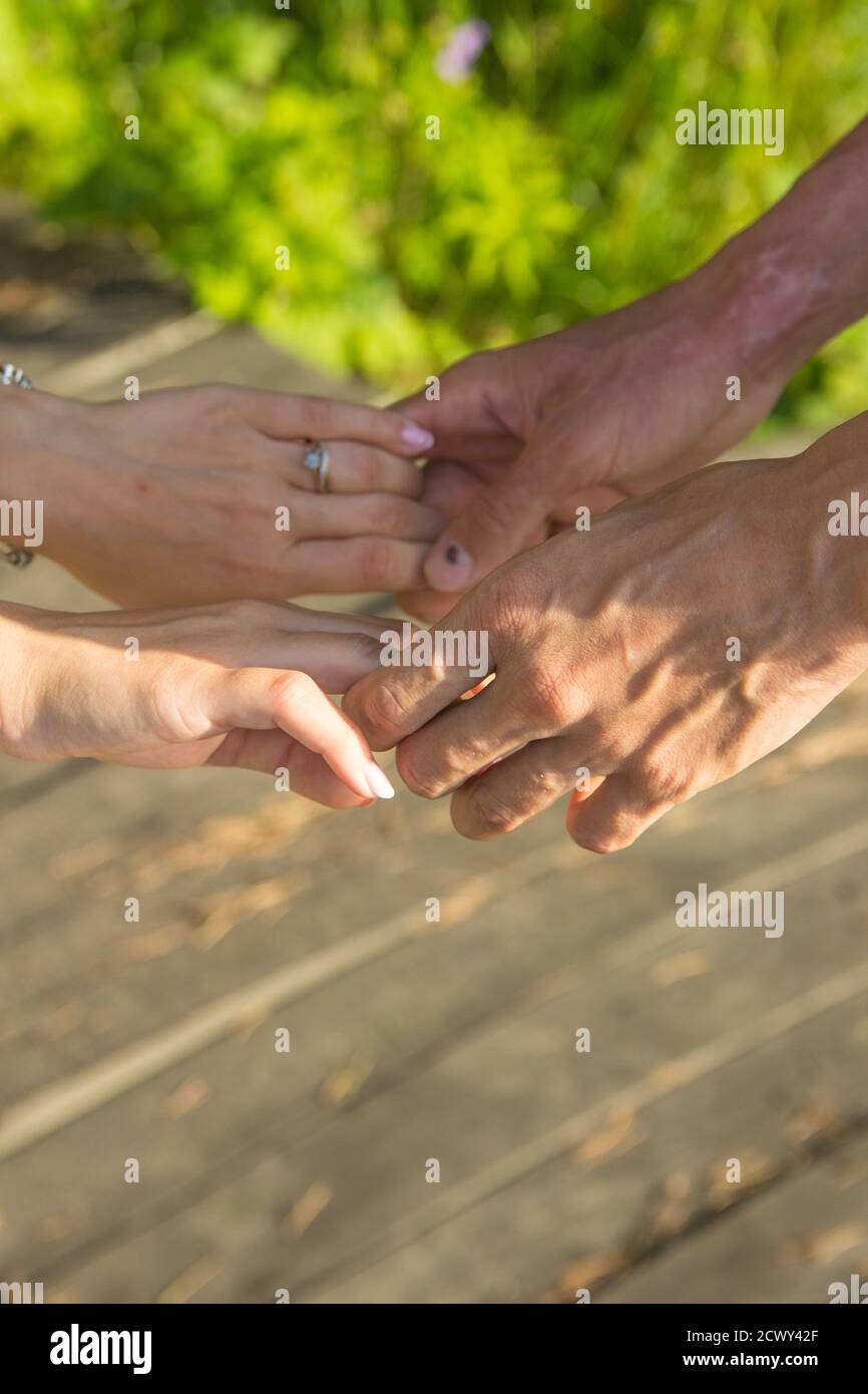 Lovers couple holding hands in a forest summer spring Stock Photo - Alamy