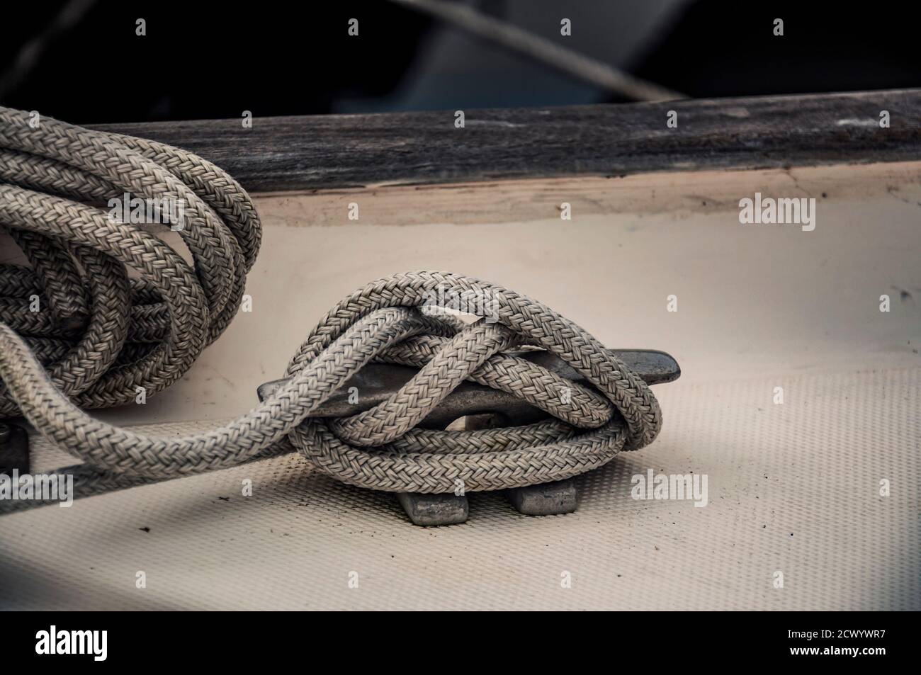 Close up of the boat cleat with a rope tied around it. Connection ...