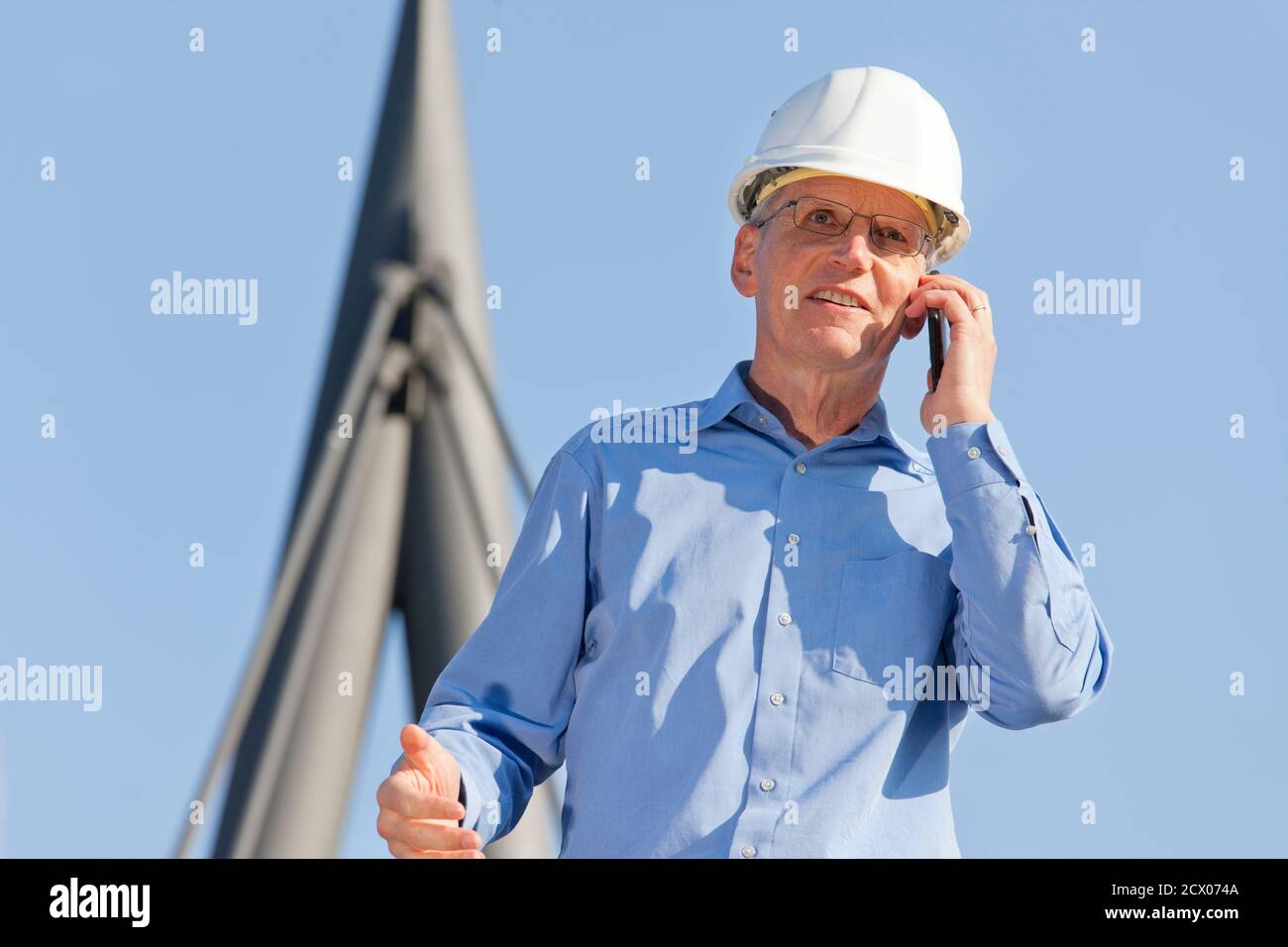 Architect or engineer talking on smart phone in front of technical ...