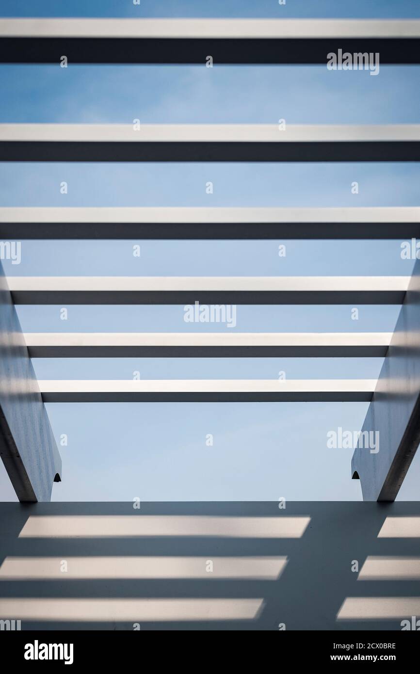 Selective shallow focus; summer sun and shadows on symmetrical gridwork ...