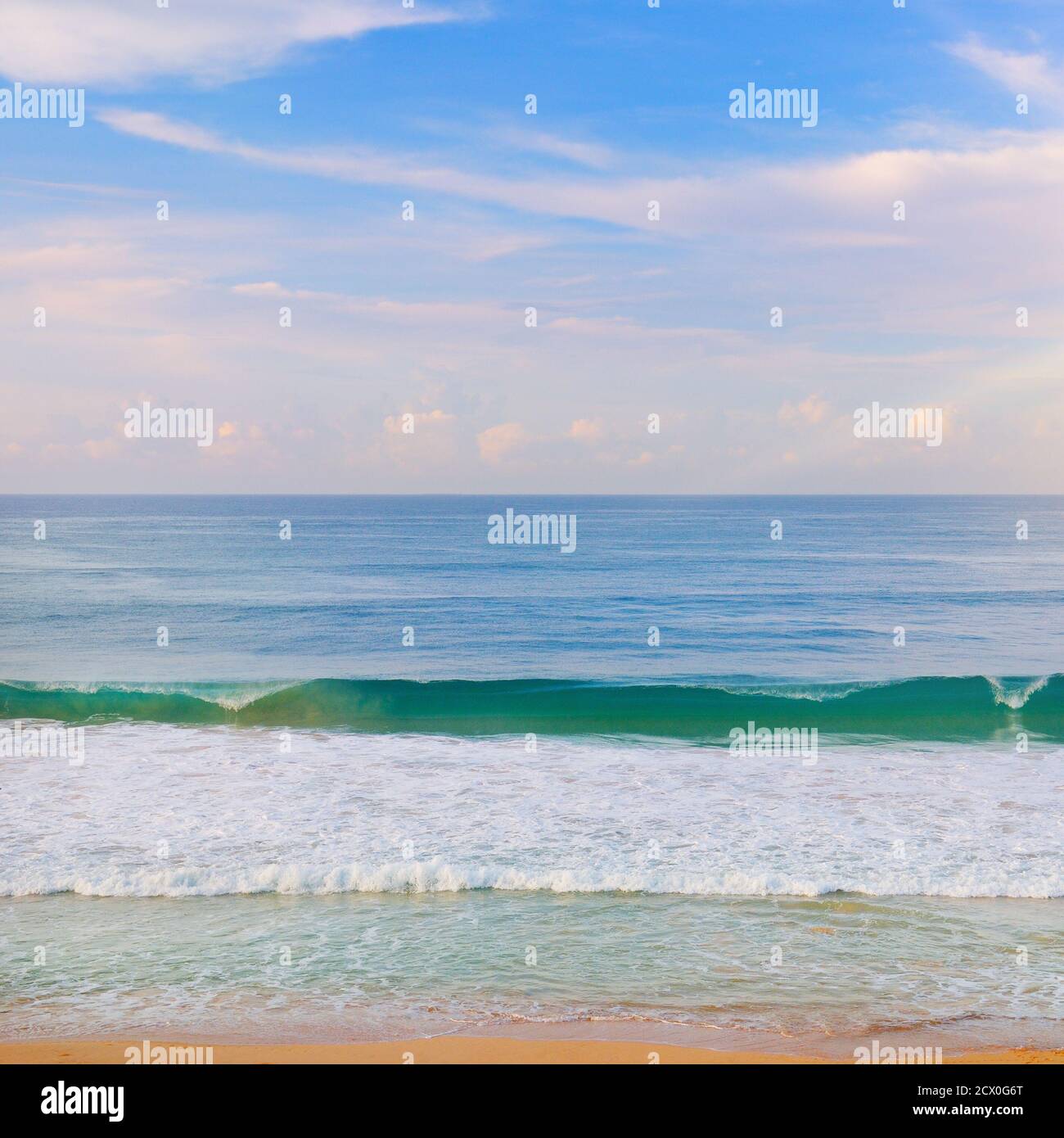 Tropical ocean,sandy beach, high waves and blue sky. Bright sunny ...
