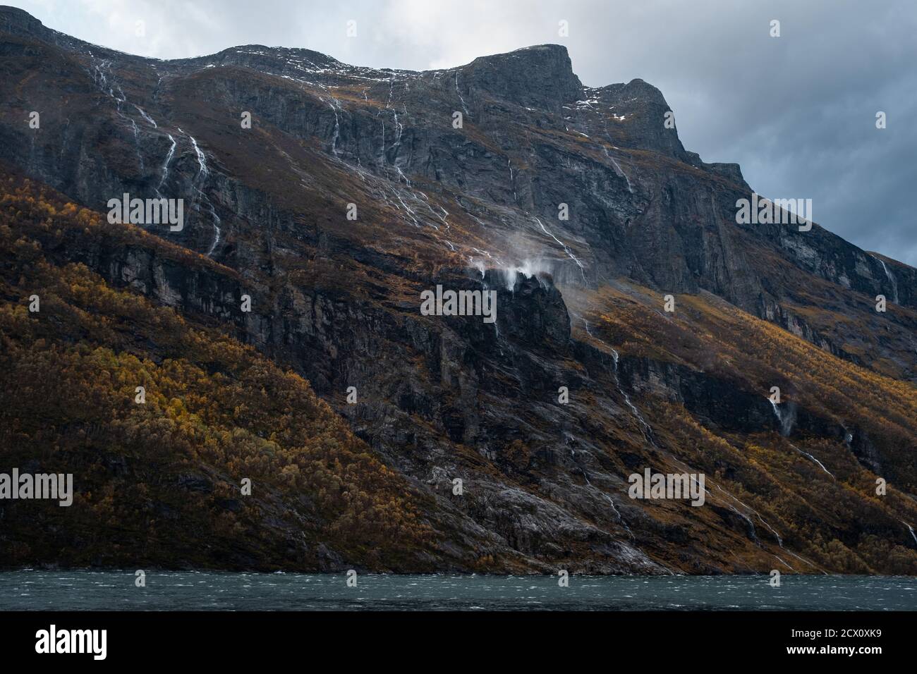 Rocky cliffside of Geirangerfjord Norway with waterfalls. Wide shot ...
