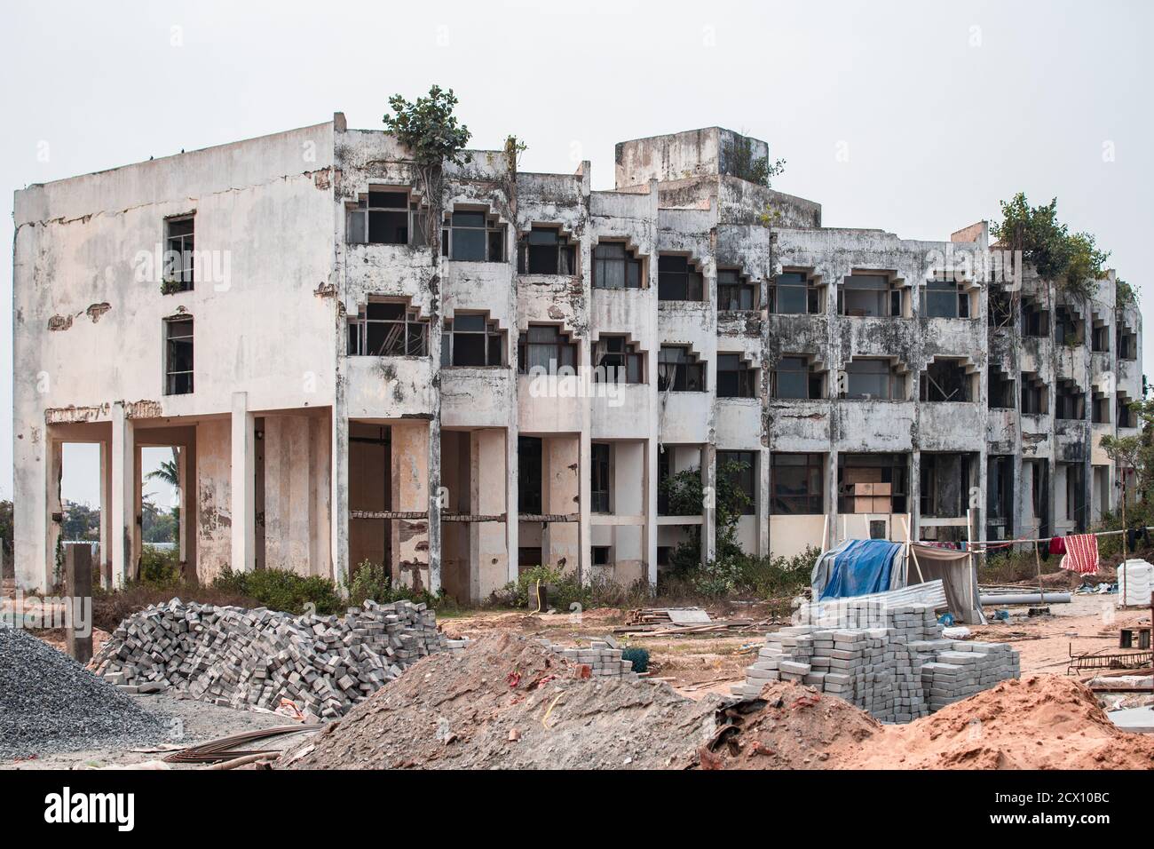 View of an old abandoned construction site of a white residential ...