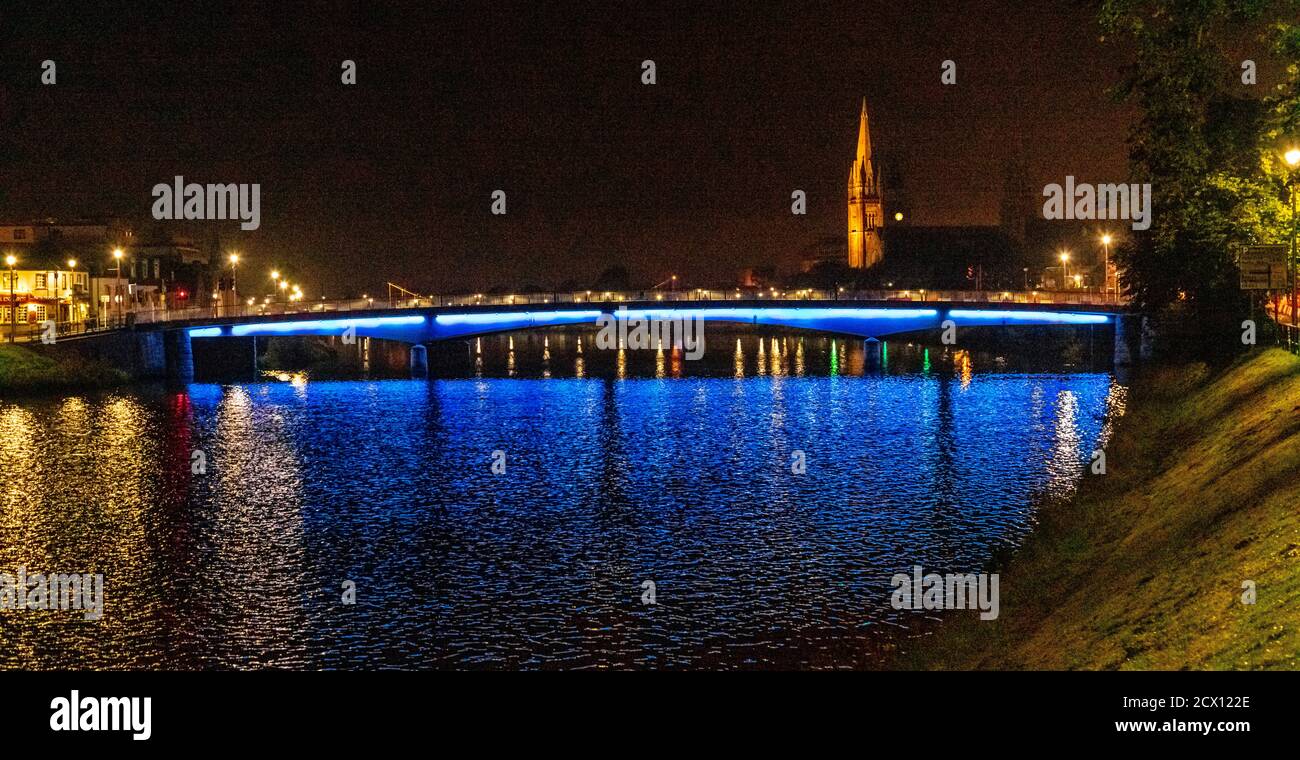 Night view of city of Inverness and bridge over River Ness illuminated ...