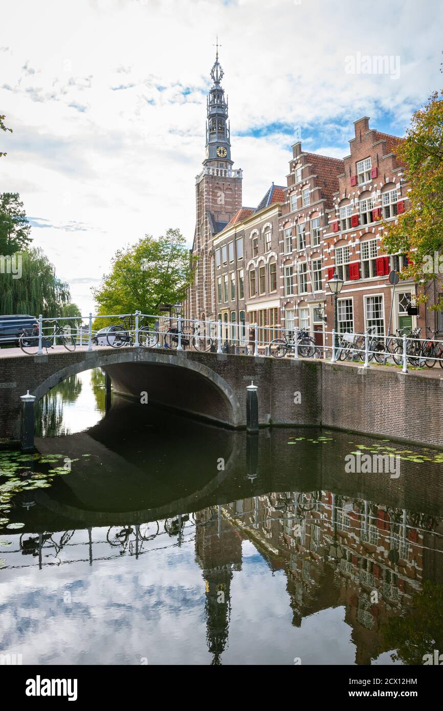 Traditional dutch canal houses and church tower in the old part of the ...