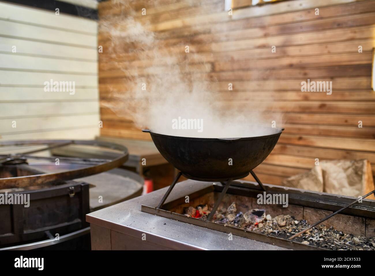 White smoke from glutinous rice steaming in countryside kitchen. Soft ...