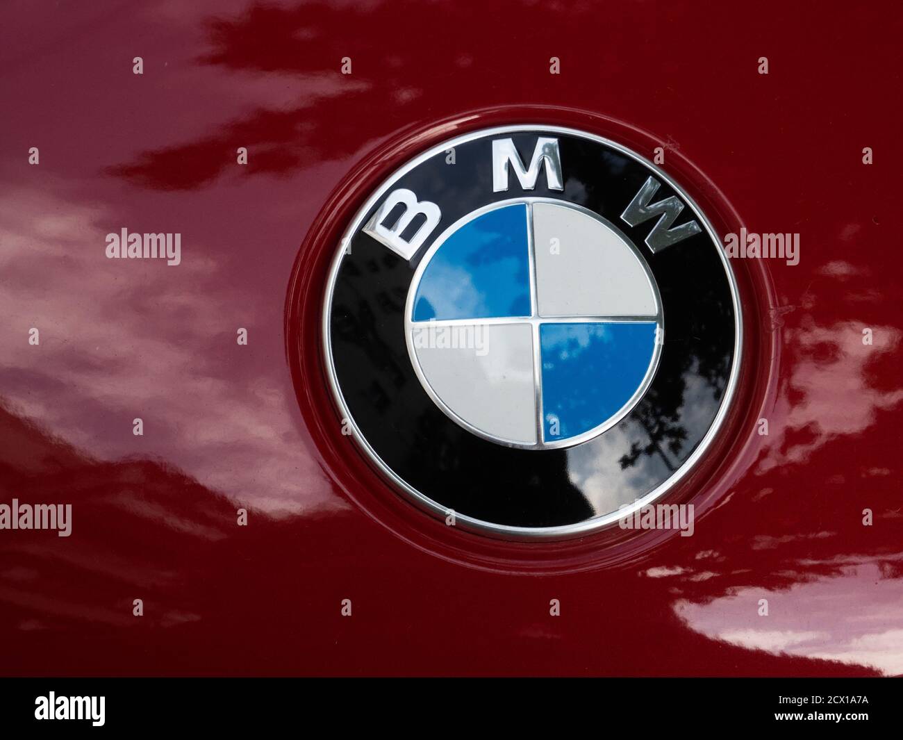 BMW logo on the hood of a red car Stock Photo - Alamy