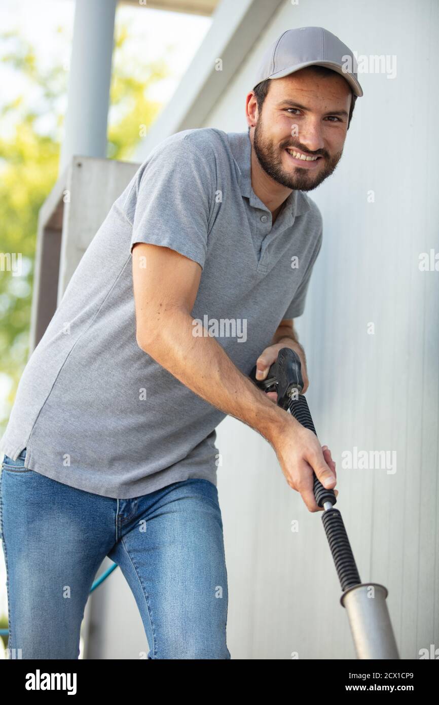 one adult man is hoovering smiling to the camera Stock Photo - Alamy