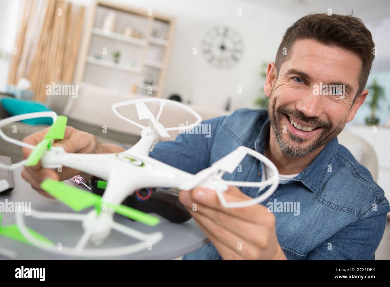 happy man is fixing a drone Stock Photo - Alamy