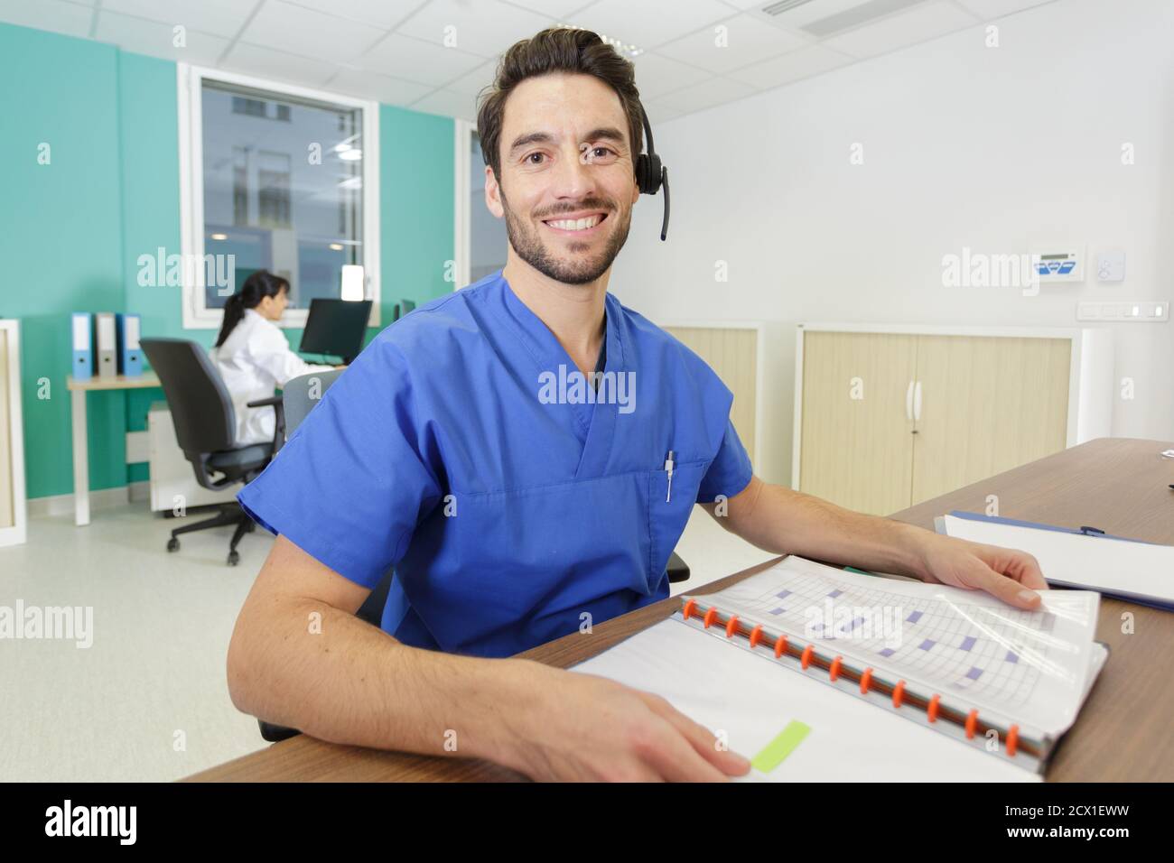 portrait of male medical secretary wearing headset Stock Photo - Alamy
