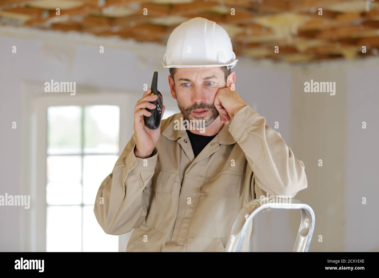 construction worker using a walkie talkie Stock Photo - Alamy