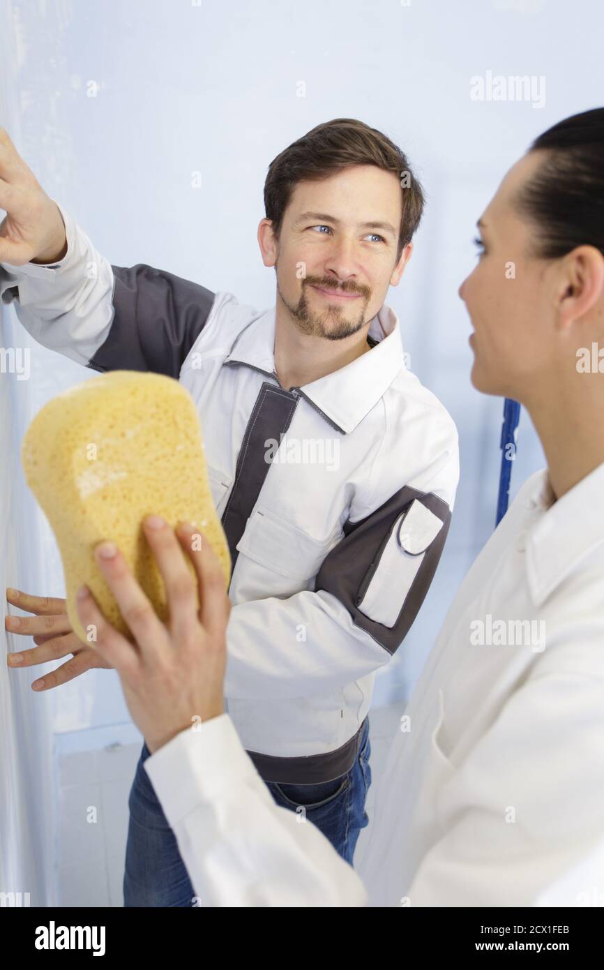 apprentice plasterer finishing wall with sponge float Stock Photo - Alamy