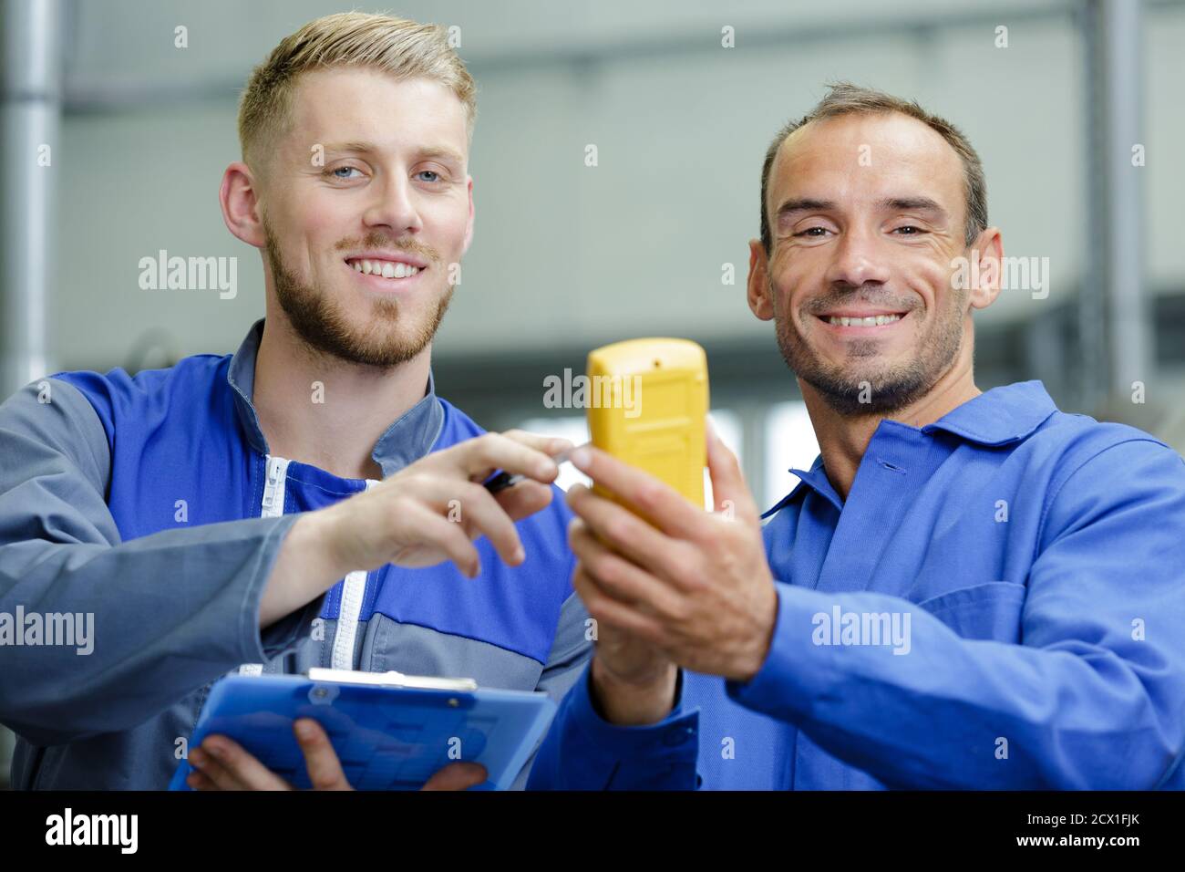 two male engineers with multi meter Stock Photo - Alamy