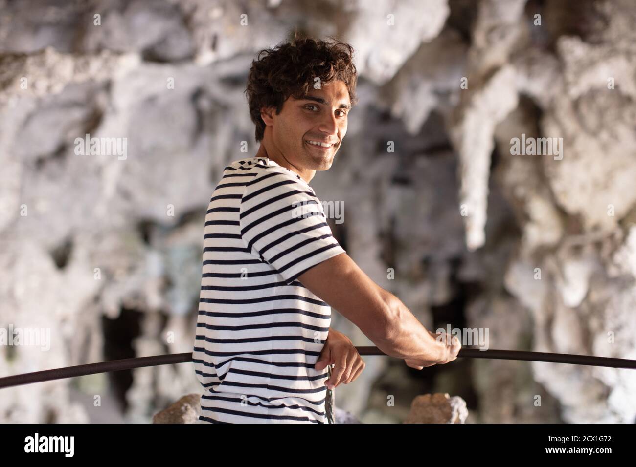 young man inside a cave posing Stock Photo - Alamy
