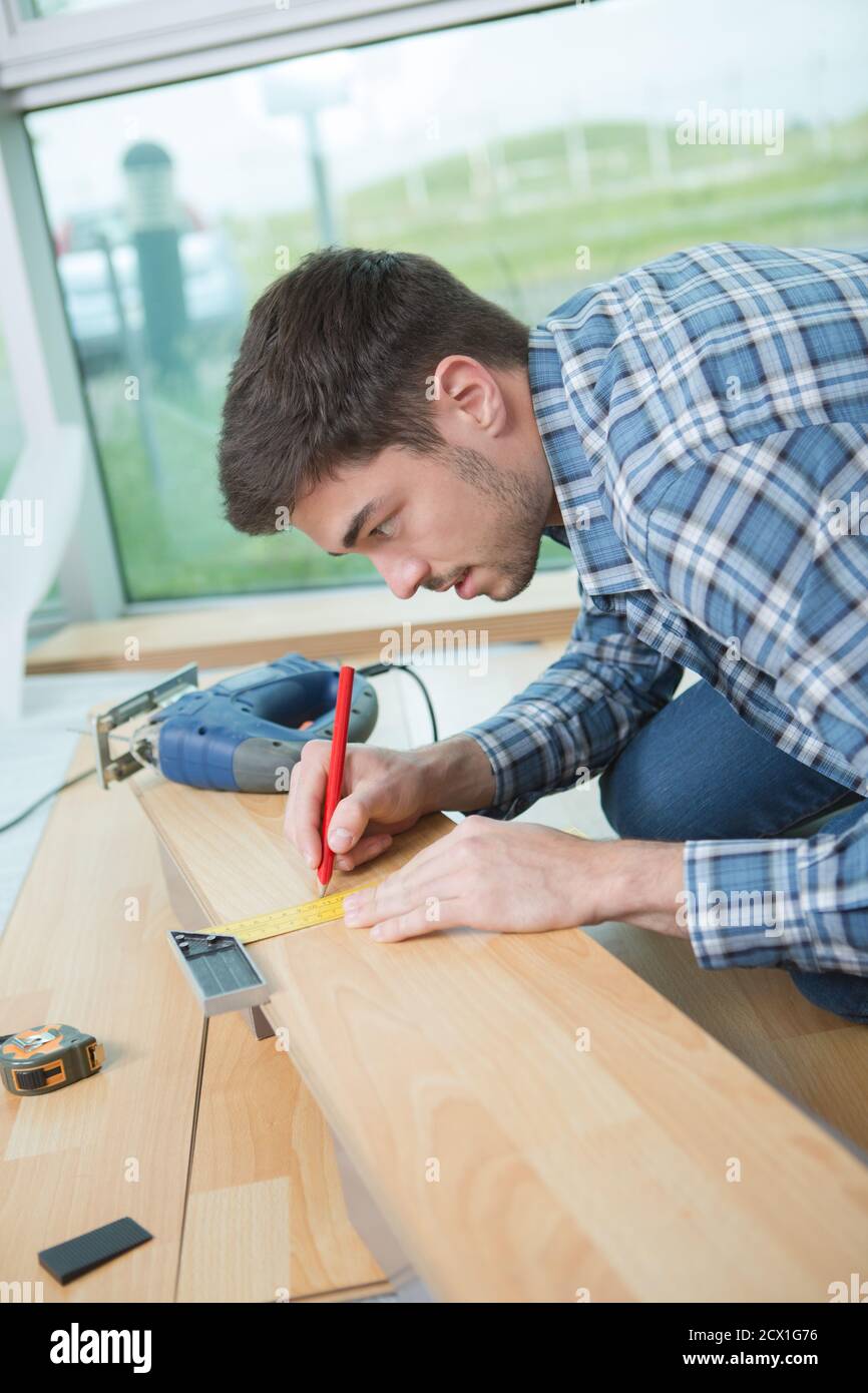 young man cutting wood board Stock Photo - Alamy