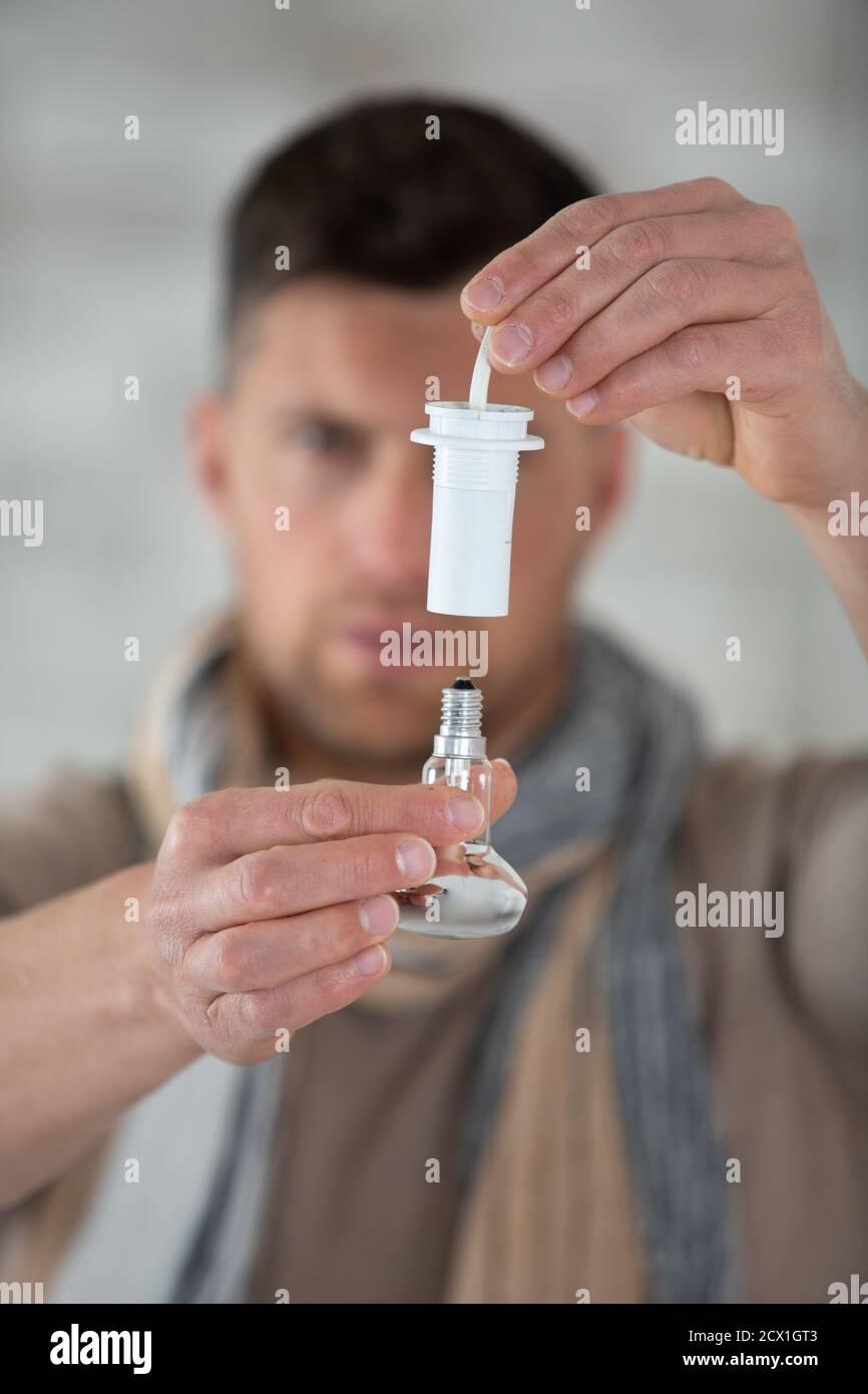 elegant man changing a lightbulb Stock Photo - Alamy