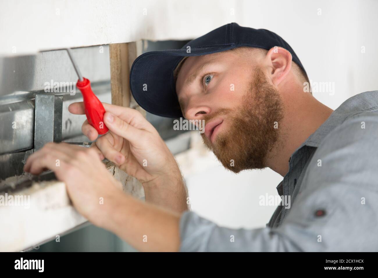 man is working of plaster around window Stock Photo - Alamy