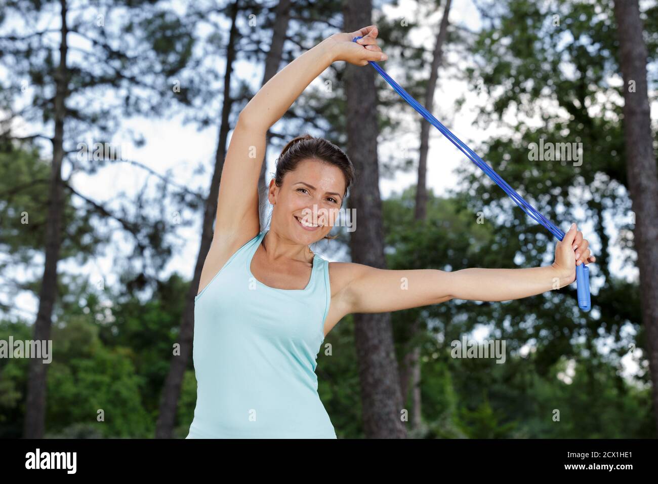 beautiful female runner stretching arms Stock Photo - Alamy