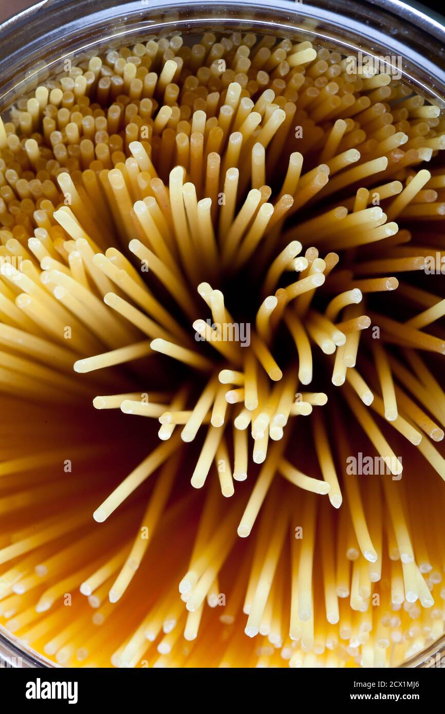 Italian spaghetti stacked in creative way and backlighted Stock Photo ...