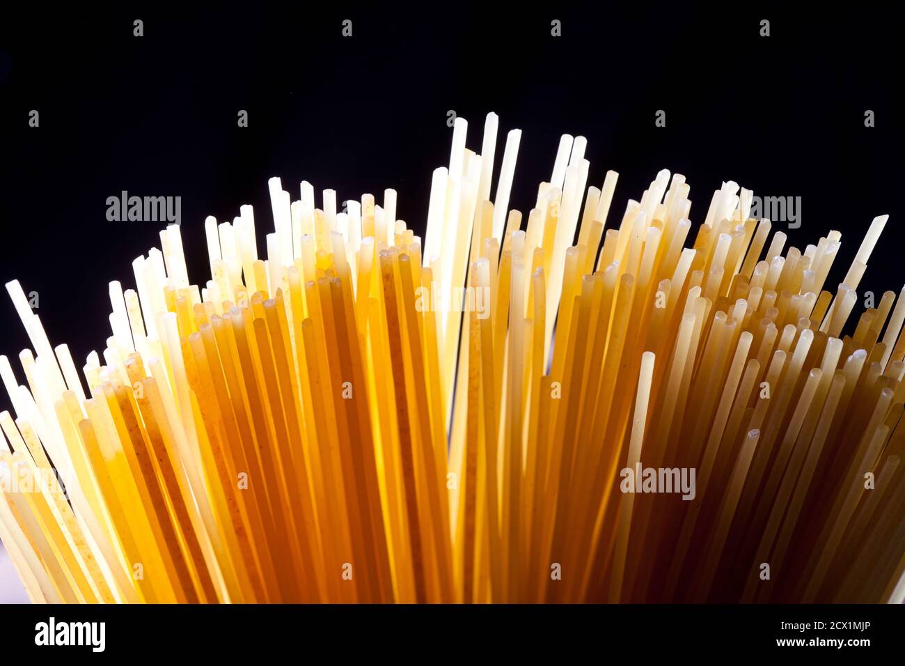 Italian spaghetti stacked in creative way and backlighted Stock Photo ...
