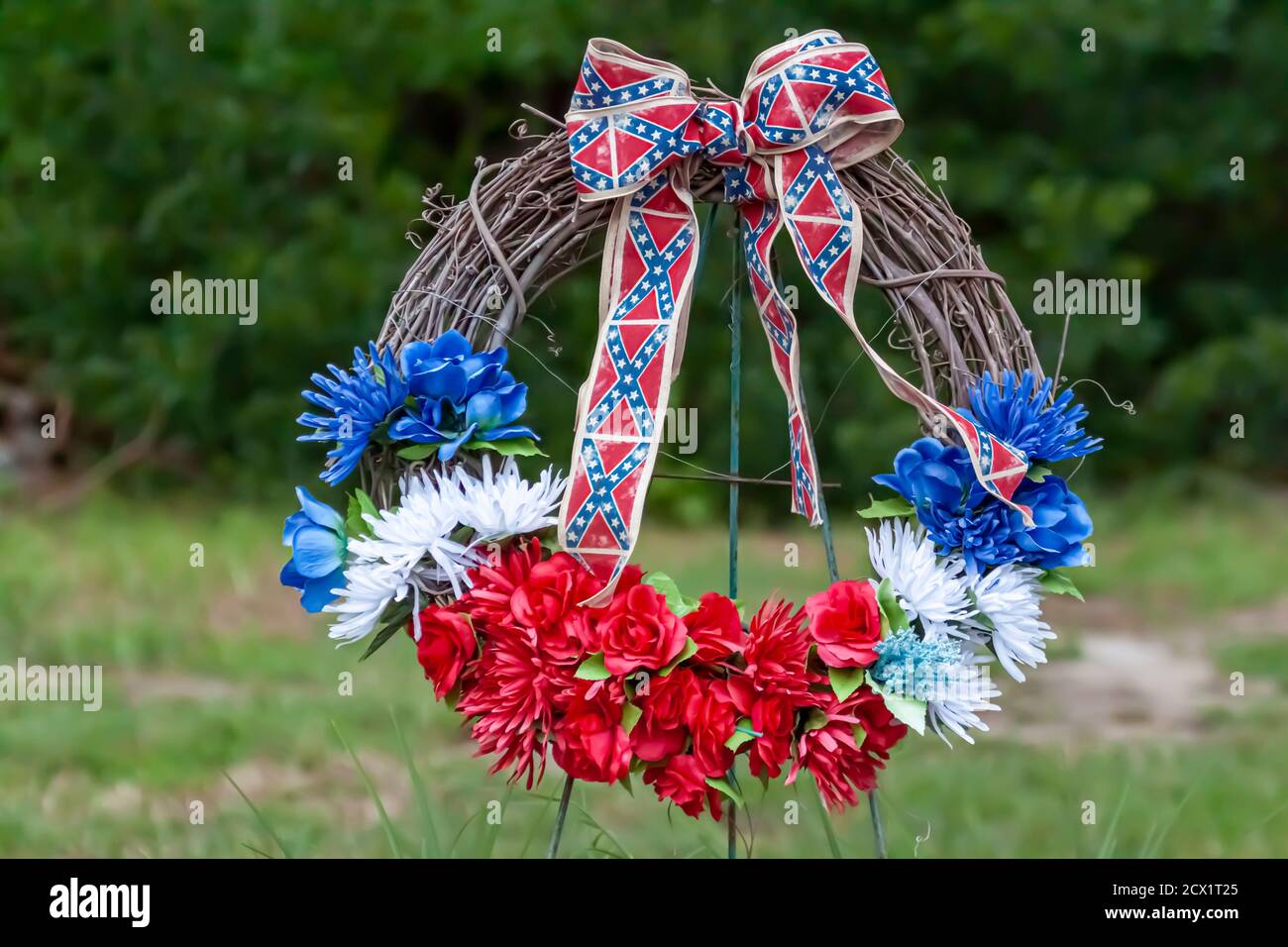 A wreath of blue, white and red flowers with Confederate flag themed ...
