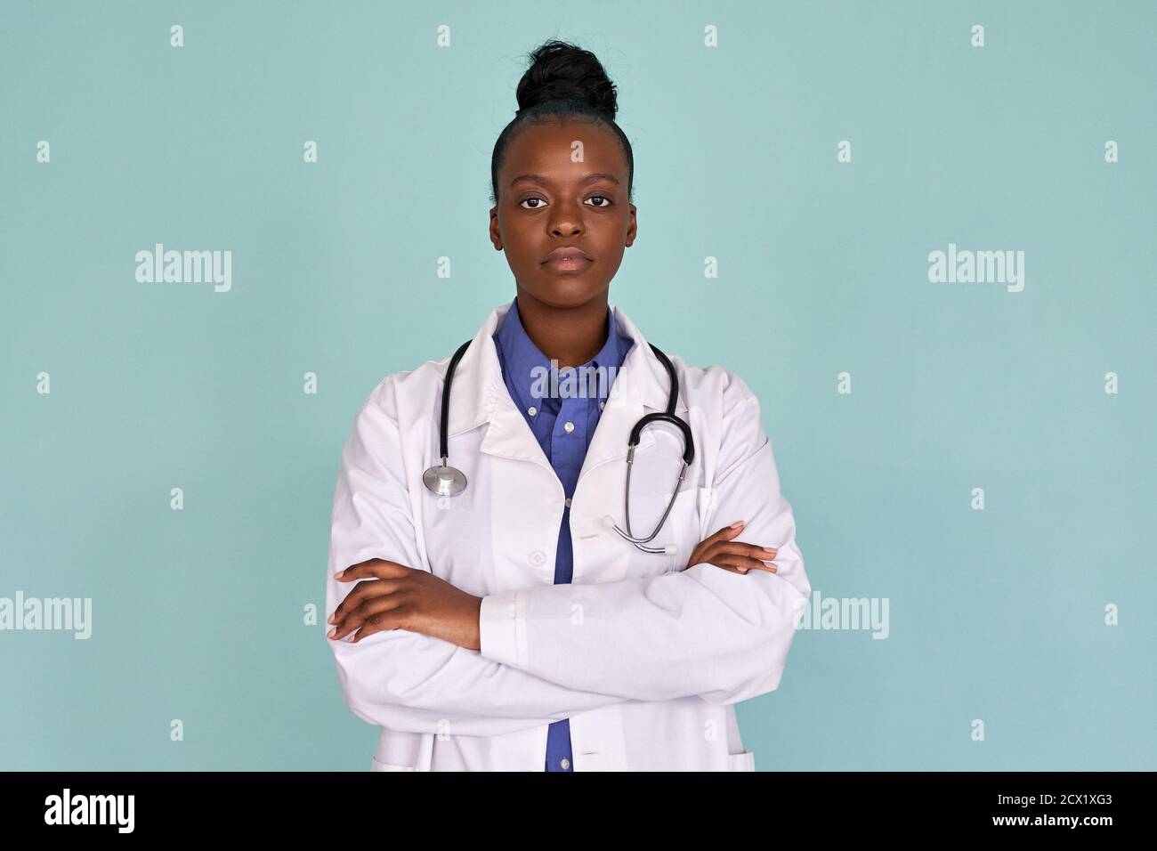 Confident african female doctor looking at camera on mint background ...