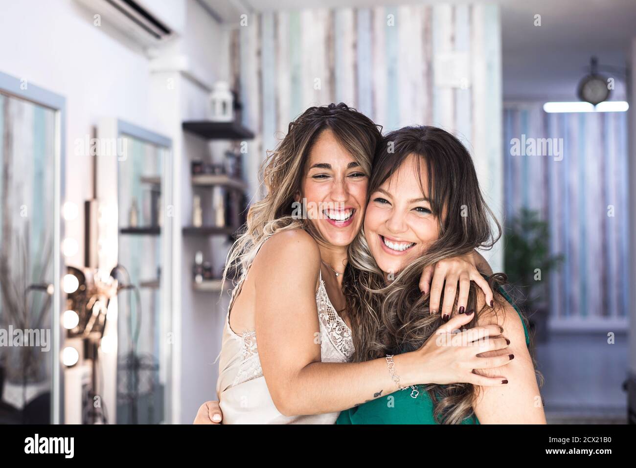 Two happy affectionate woman hugging each other in close embrace Stock ...